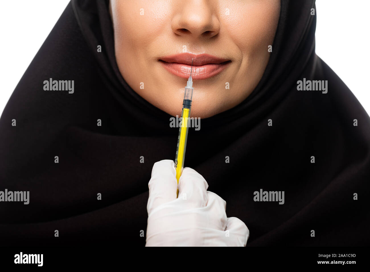 partial view of young Muslim woman in hijab having beauty injection ...
