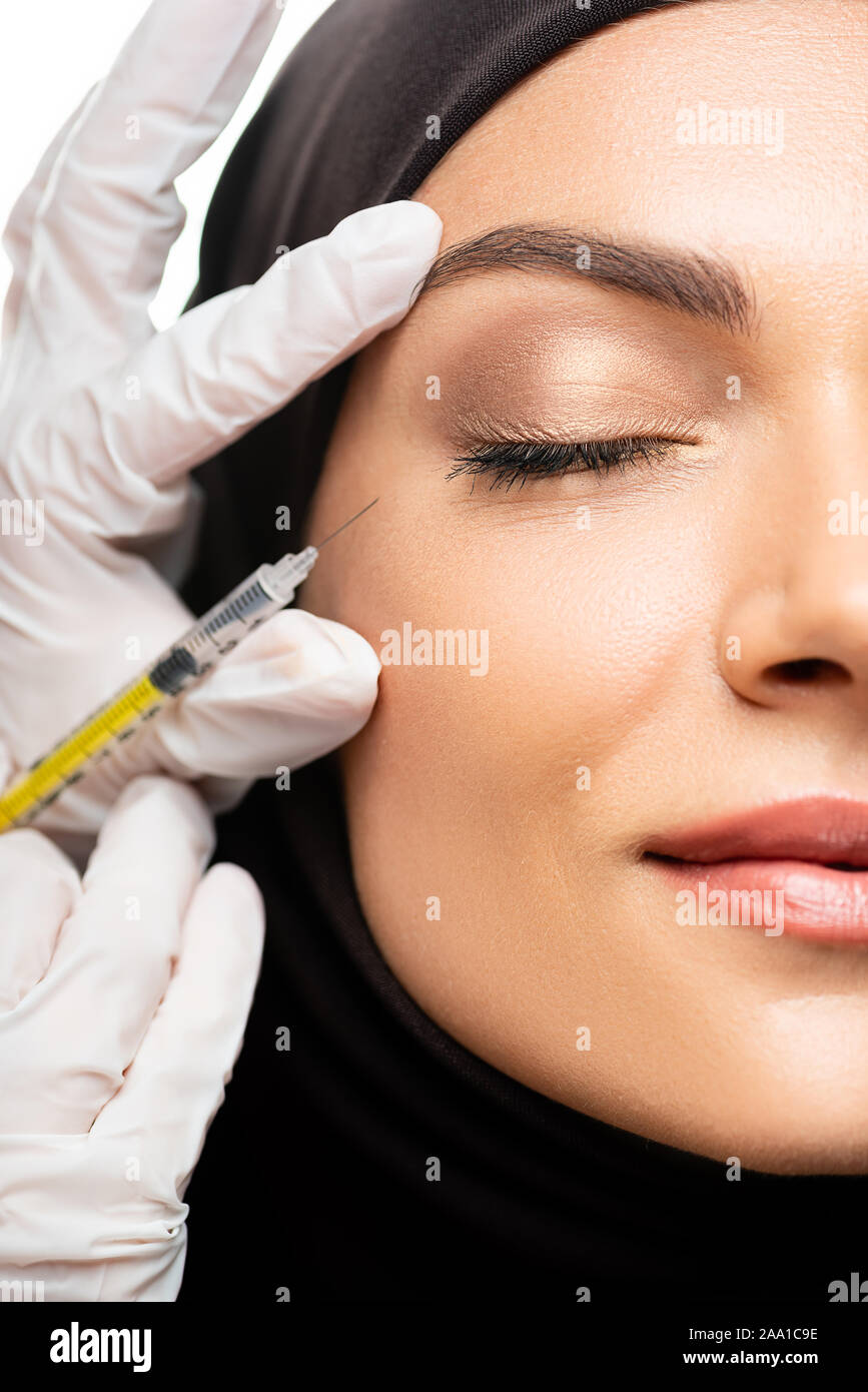 close up view of young Muslim woman in hijab having beauty injection ...