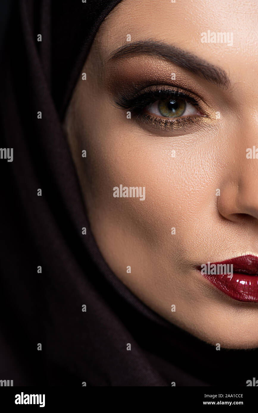 close up view of young Muslim woman in hijab with smoky eyes and red ...