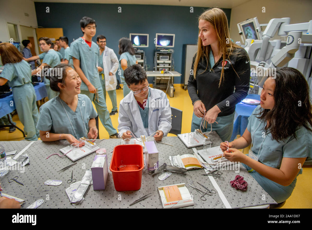 A college coach mentor encourages Asian American teenagers at a summer ...