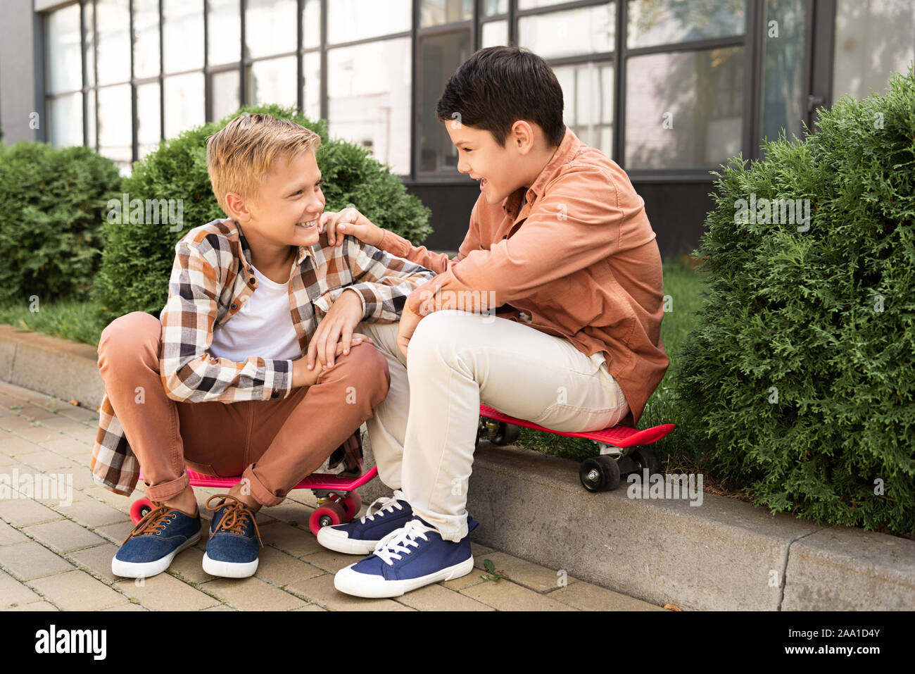 Two brothers talking together sitting hi-res stock photography and ...