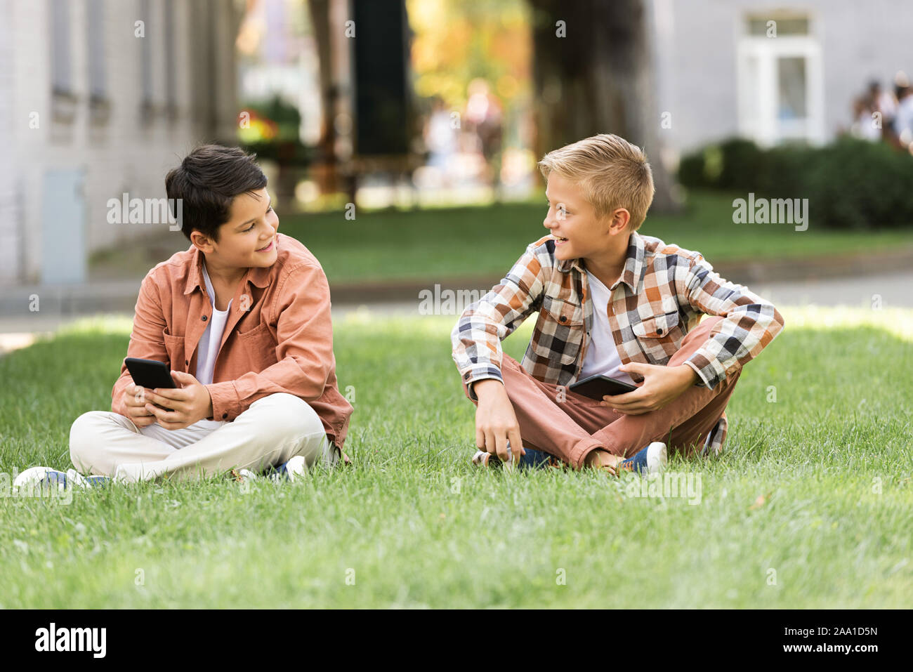 Two brothers talking together sitting hi-res stock photography and ...