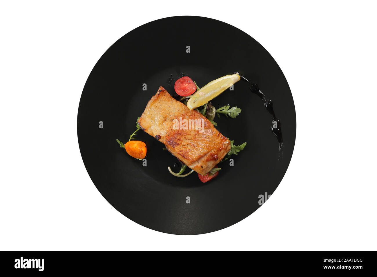 Fried fish fillet on black plate isolated on white background Stock ...