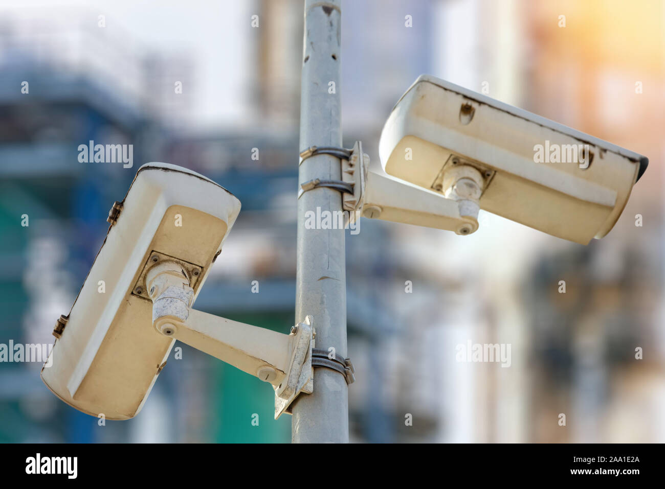CCTV camera concept with refinery on blurry background Stock Photo - Alamy