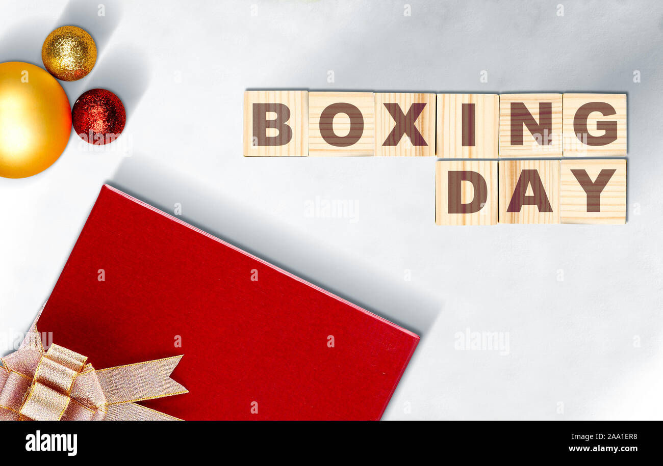 Gift box with a ribbon and Christmas ornament with Boxing Day text on a ...