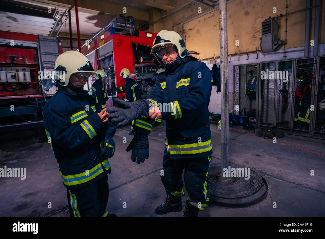 Firefighters preparing their uniform and the firetruck in the ...