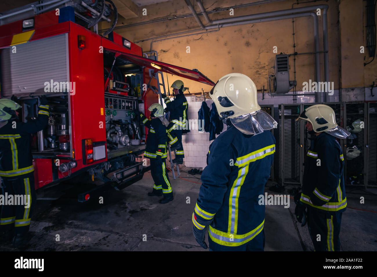 Firefighters preparing their uniform and the firetruck in the ...