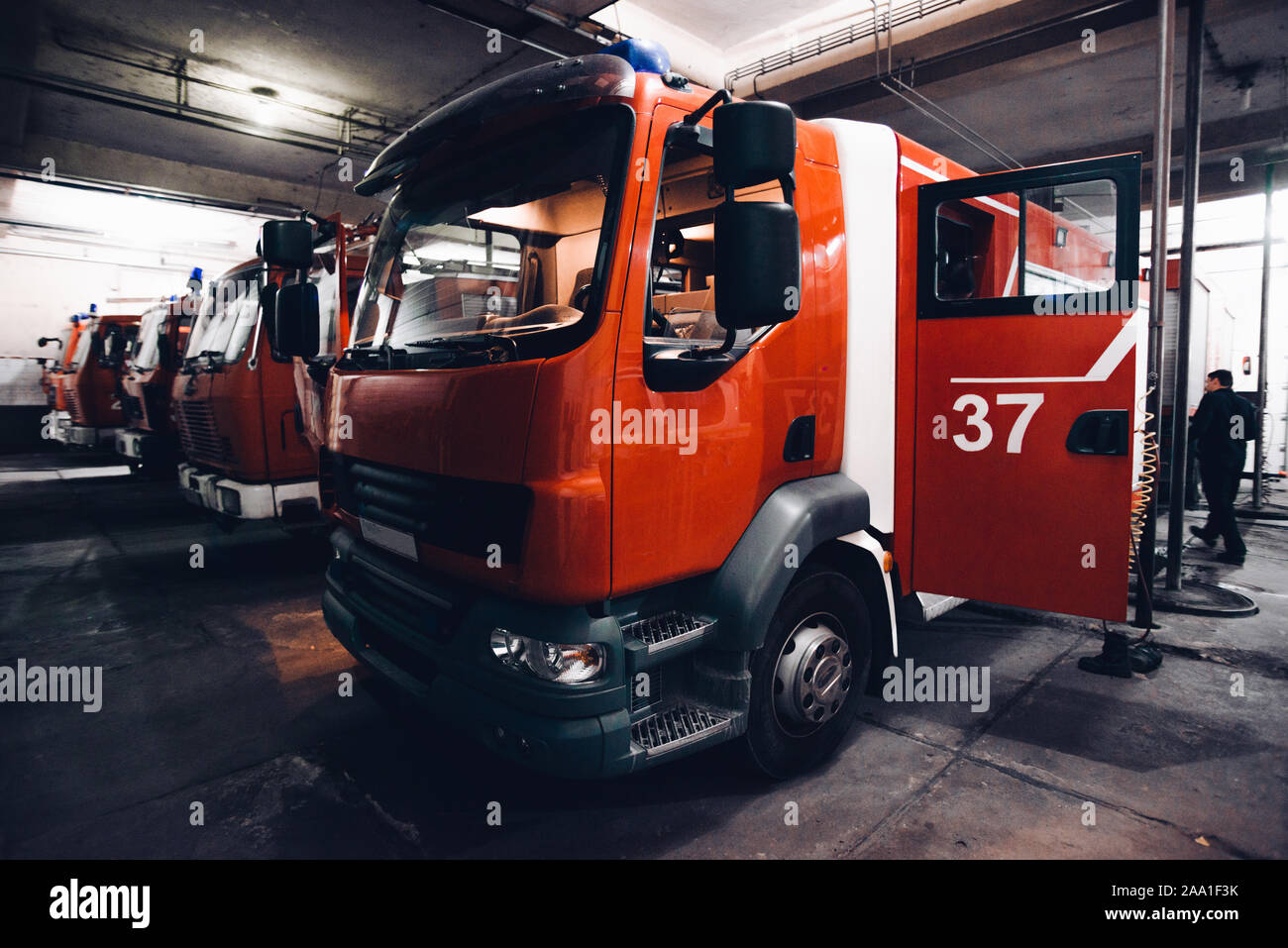 Multiple fire trucks parked in a garage used for firefighting ...