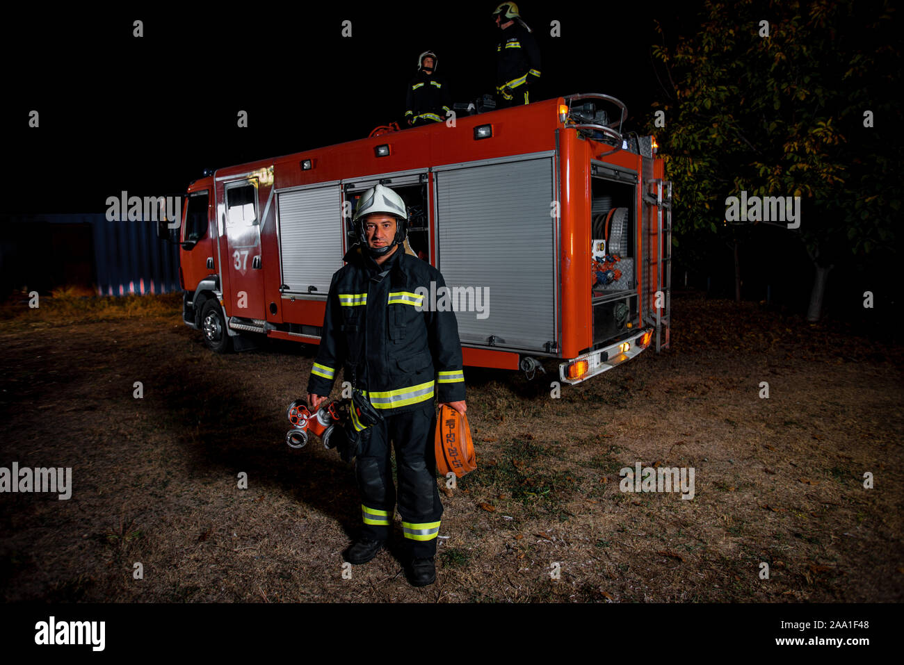 Firemen getting ready during a firefighting intervention Stock Photo ...