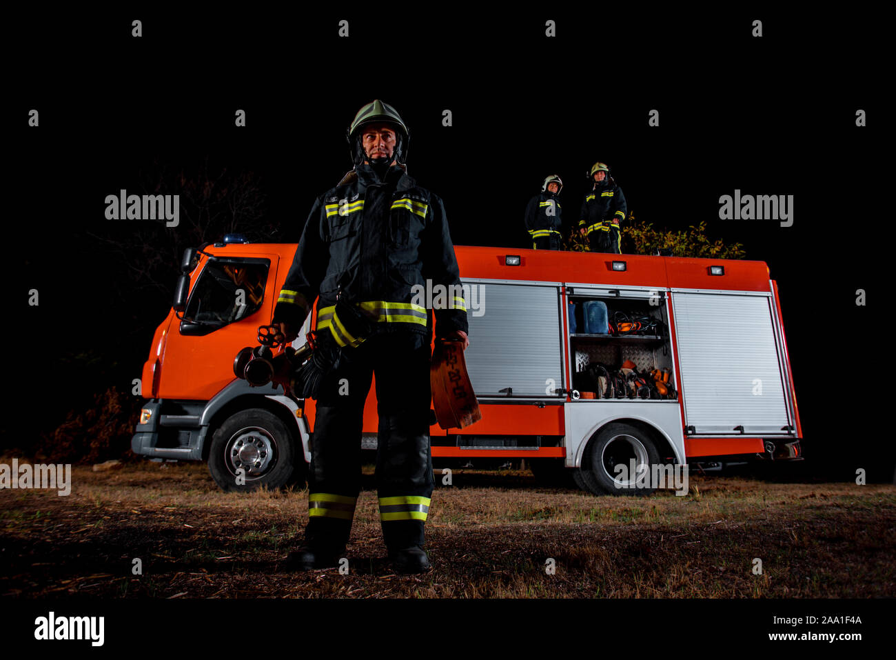 Fire brigade during operation in the field at night time Stock Photo ...