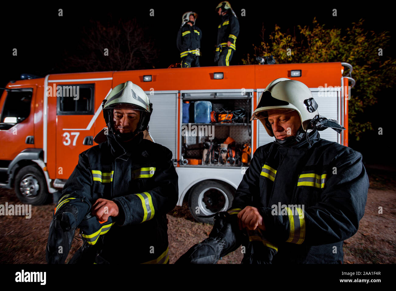 Firemen getting ready during a firefighting intervention Stock Photo ...
