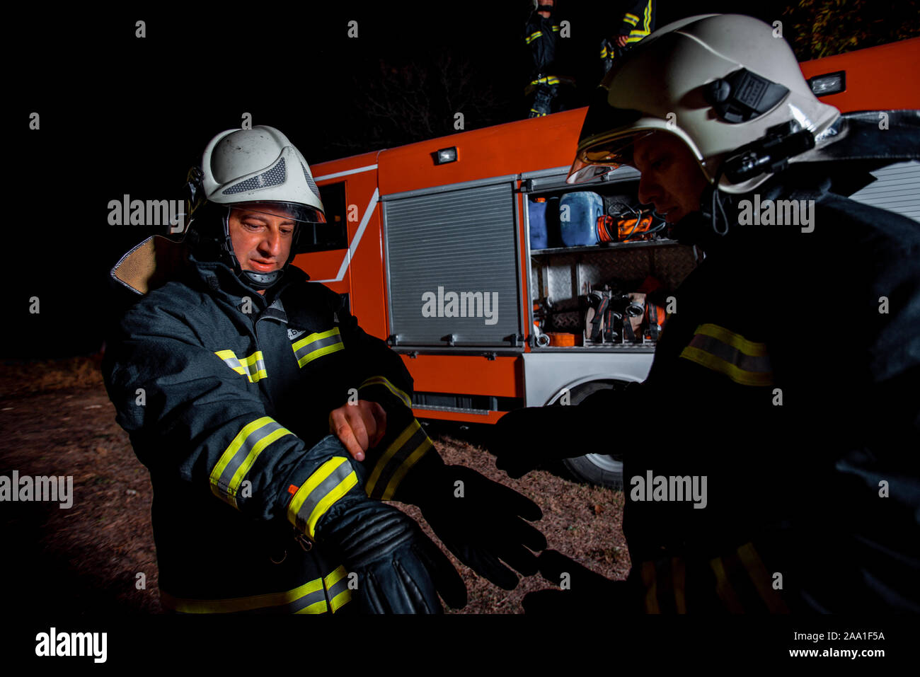 Firemen outfitted with gear during a firefighting operation Stock Photo ...