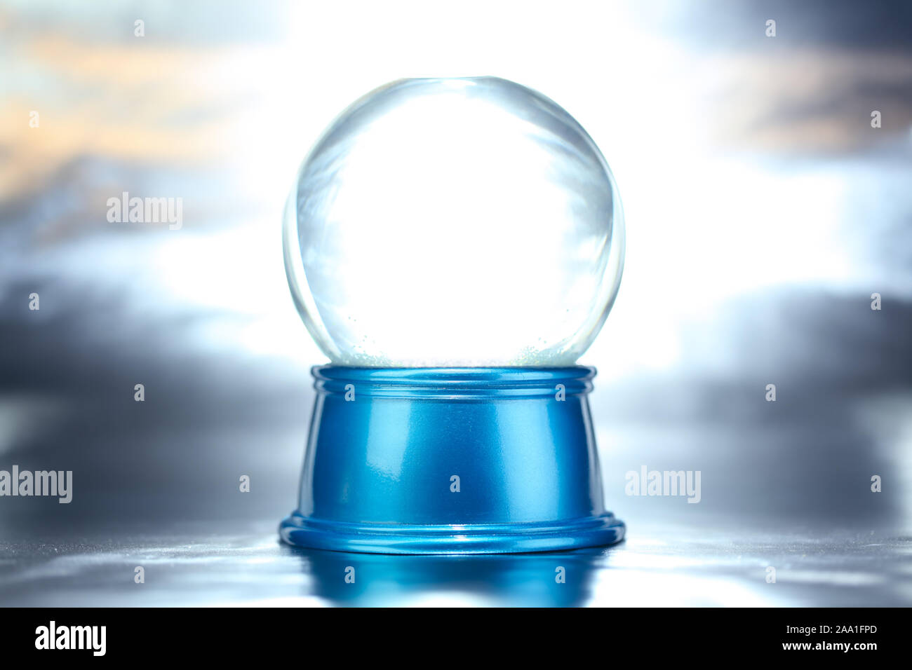 Blank empty snowglobe. Glass snow globe on blue base Stock Photo - Alamy