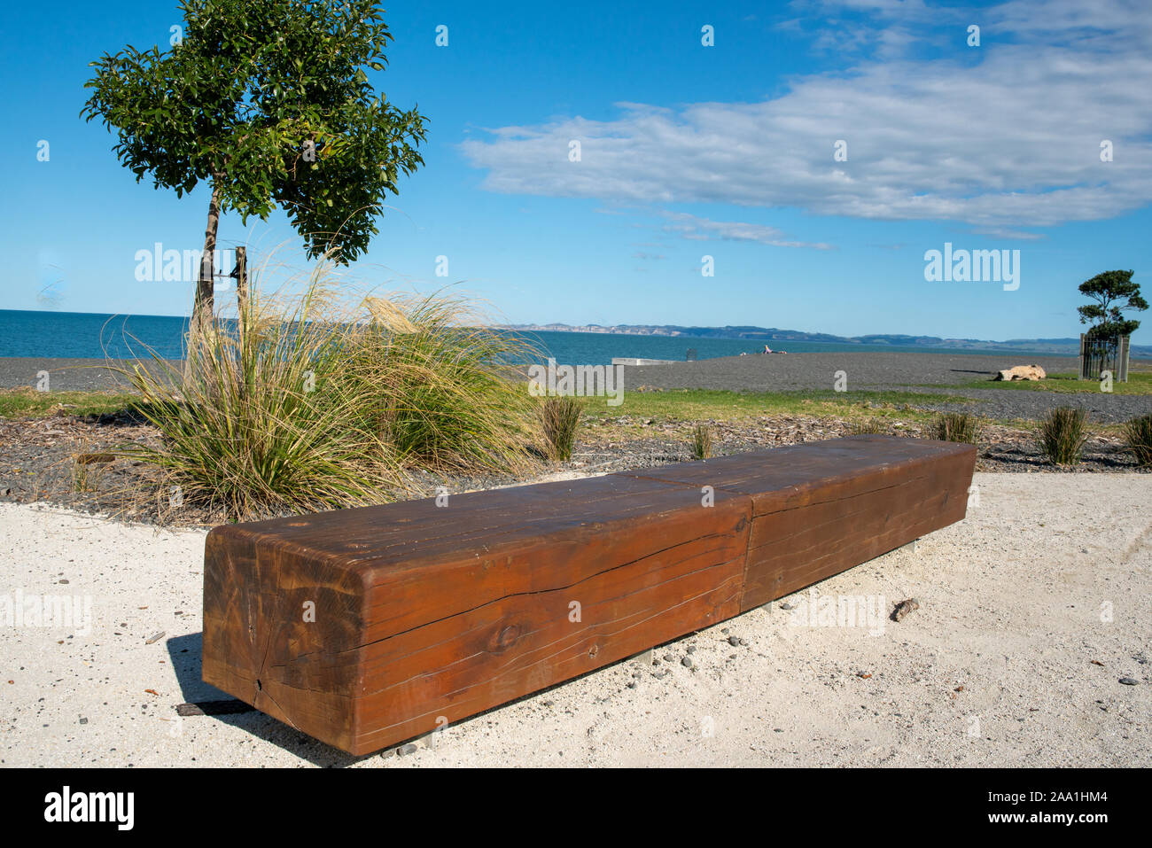 Beautiful modern wooden bench in the public park by the beach and coast ...