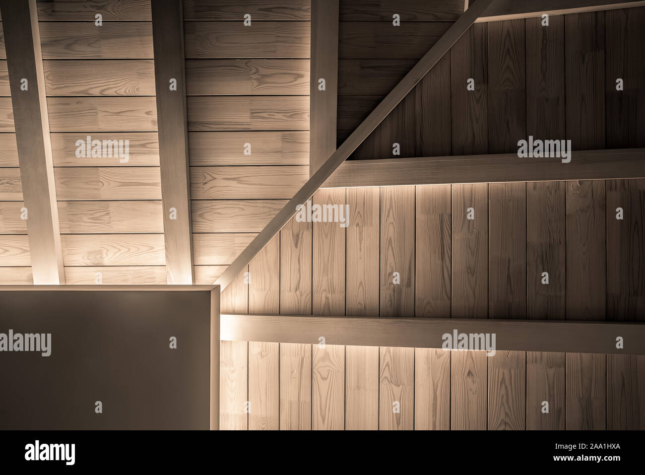 Textured light wooden ceiling with illumination indoors. Closeup ...