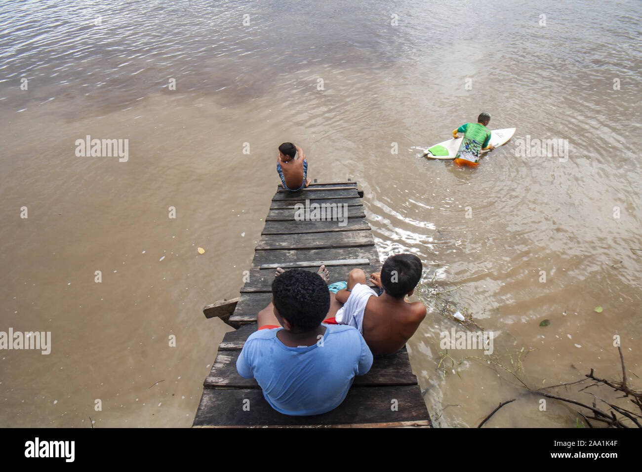Boys waiting for the pororoca to surf Stock Photo - Alamy