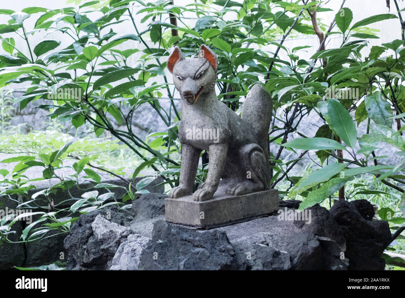 Stone Statue of Fox in Woods Stock Photo - Alamy