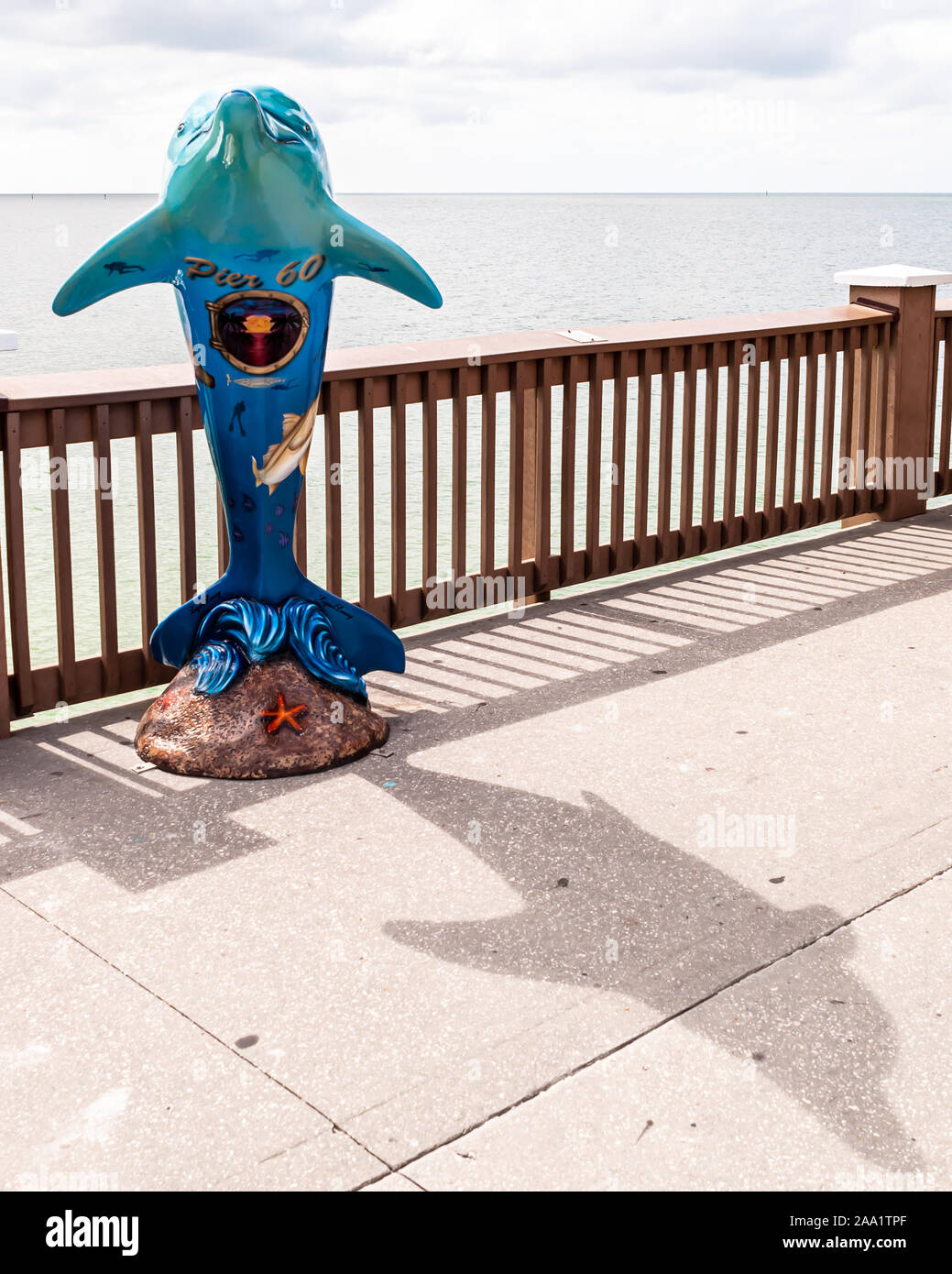 A dolphin statue on Pier 60 overlooking the Gulf of Mexico on a sunny ...