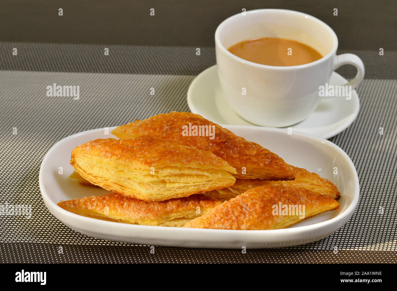 Sugar puff pastry or sugar khari with a cup of tea Stock Photo - Alamy