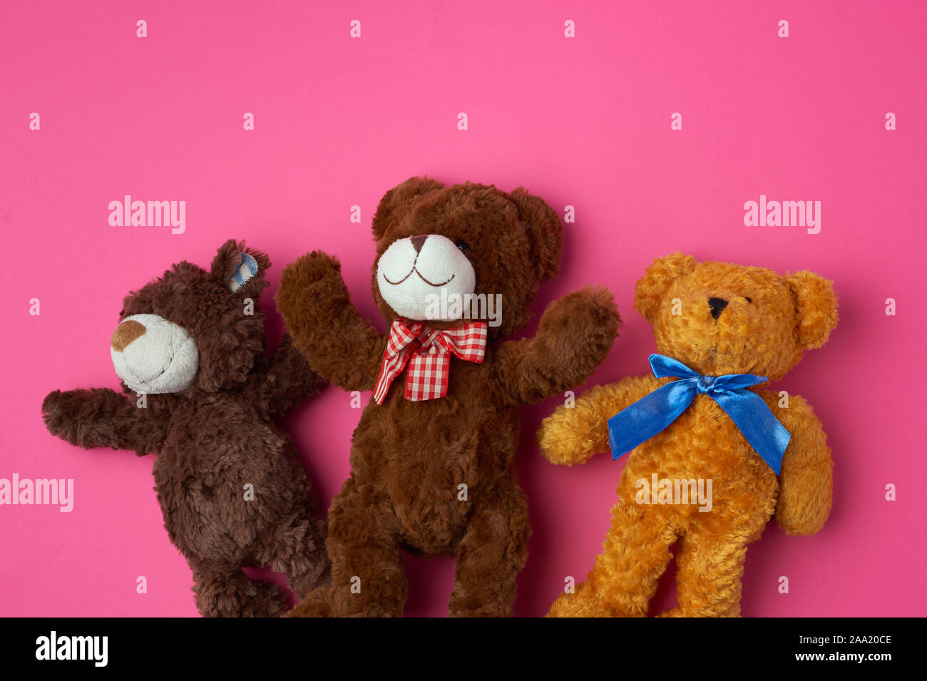 three teddy bears on a pink background, friendship concept, close up ...