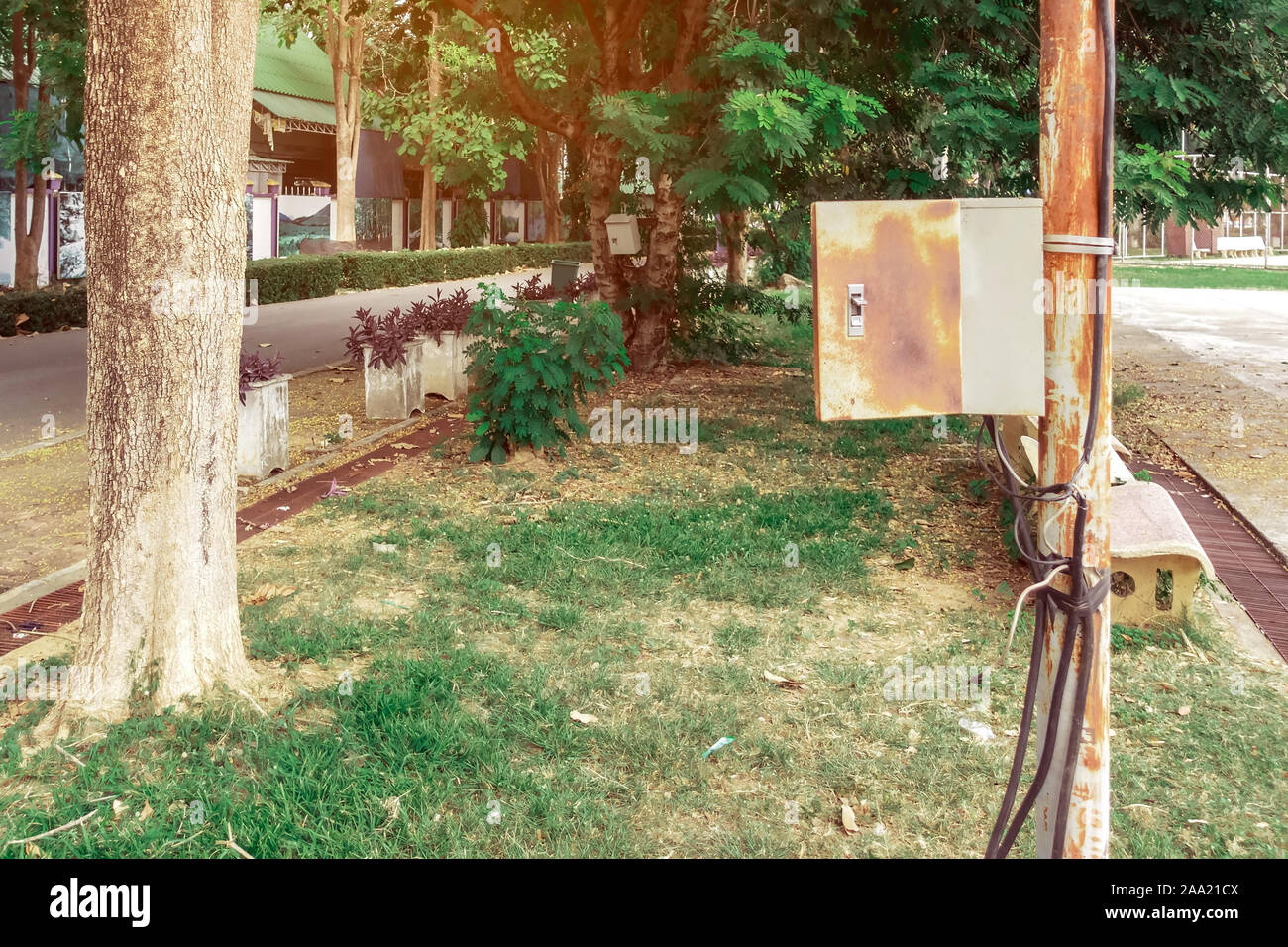 Old rusty electrical power control box on rusted electric pole in the ...