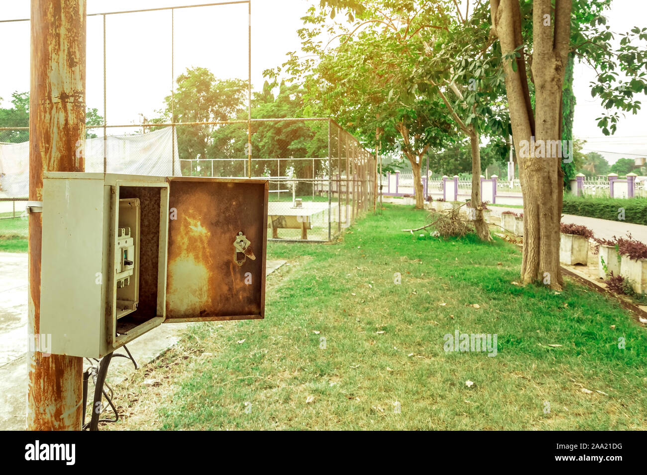 Old rusty electrical power control box on rusted electric pole in the ...
