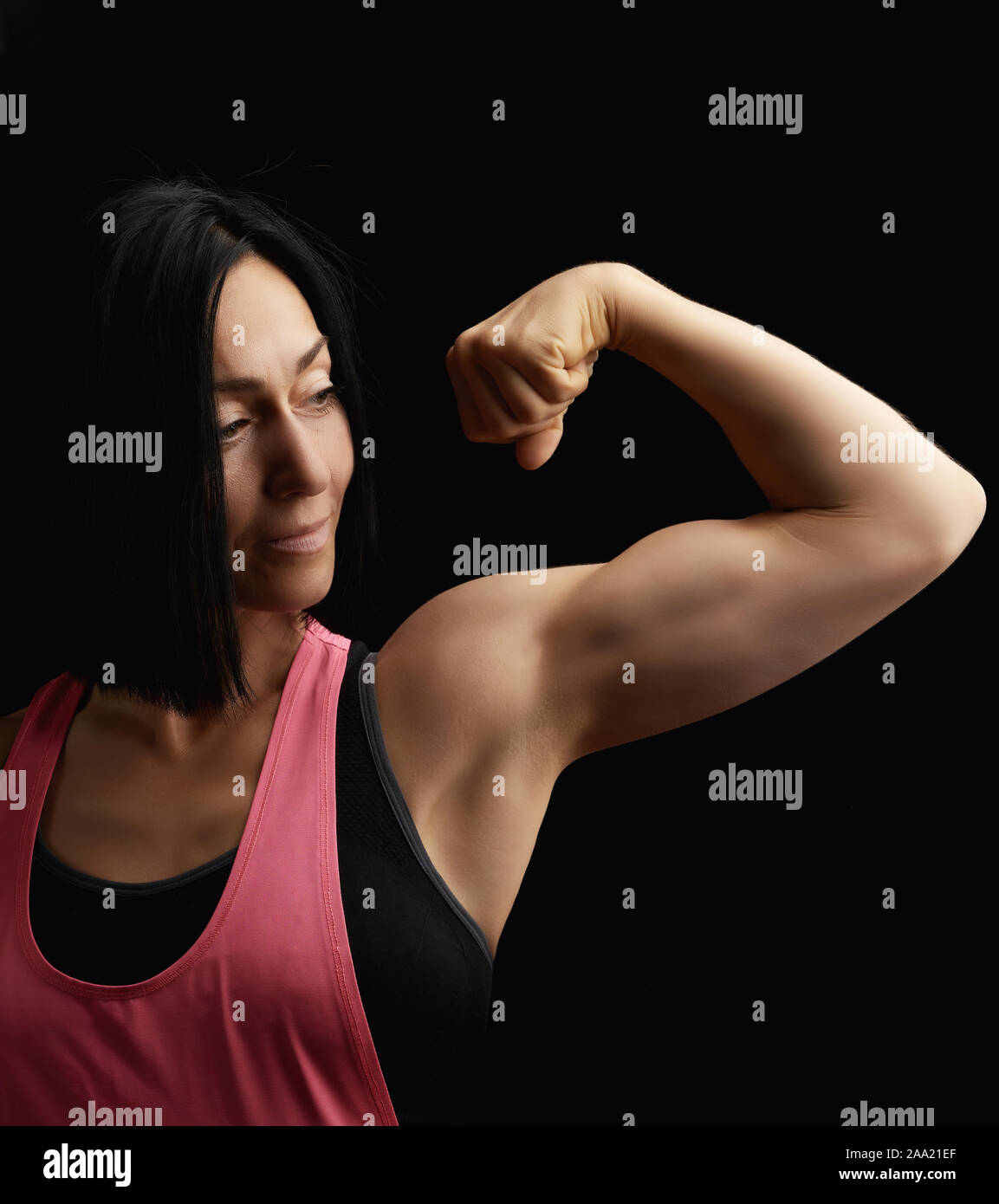 beautiful athletic girl raised and bent her arm demonstrating her ...