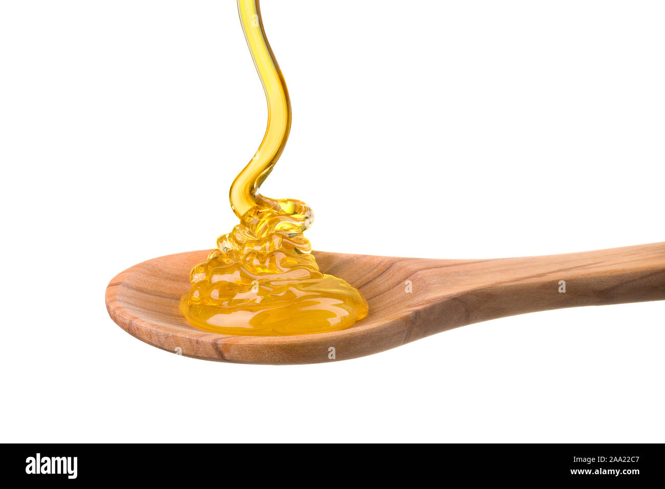 Falling and flowing honey on a wooden spoon isolated on white with ...