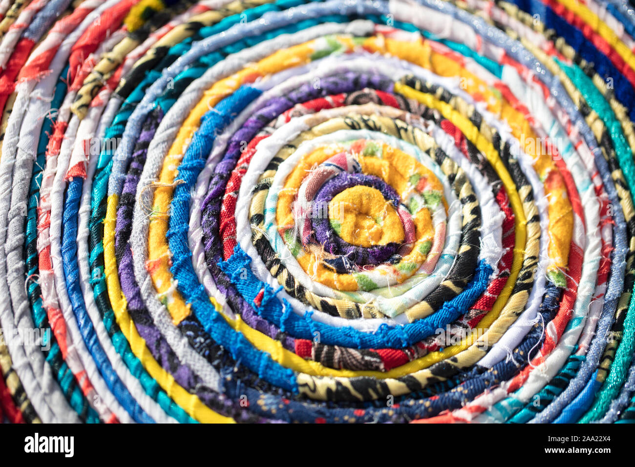 Background roll of twisted fabric close-up. Many rags of different ...