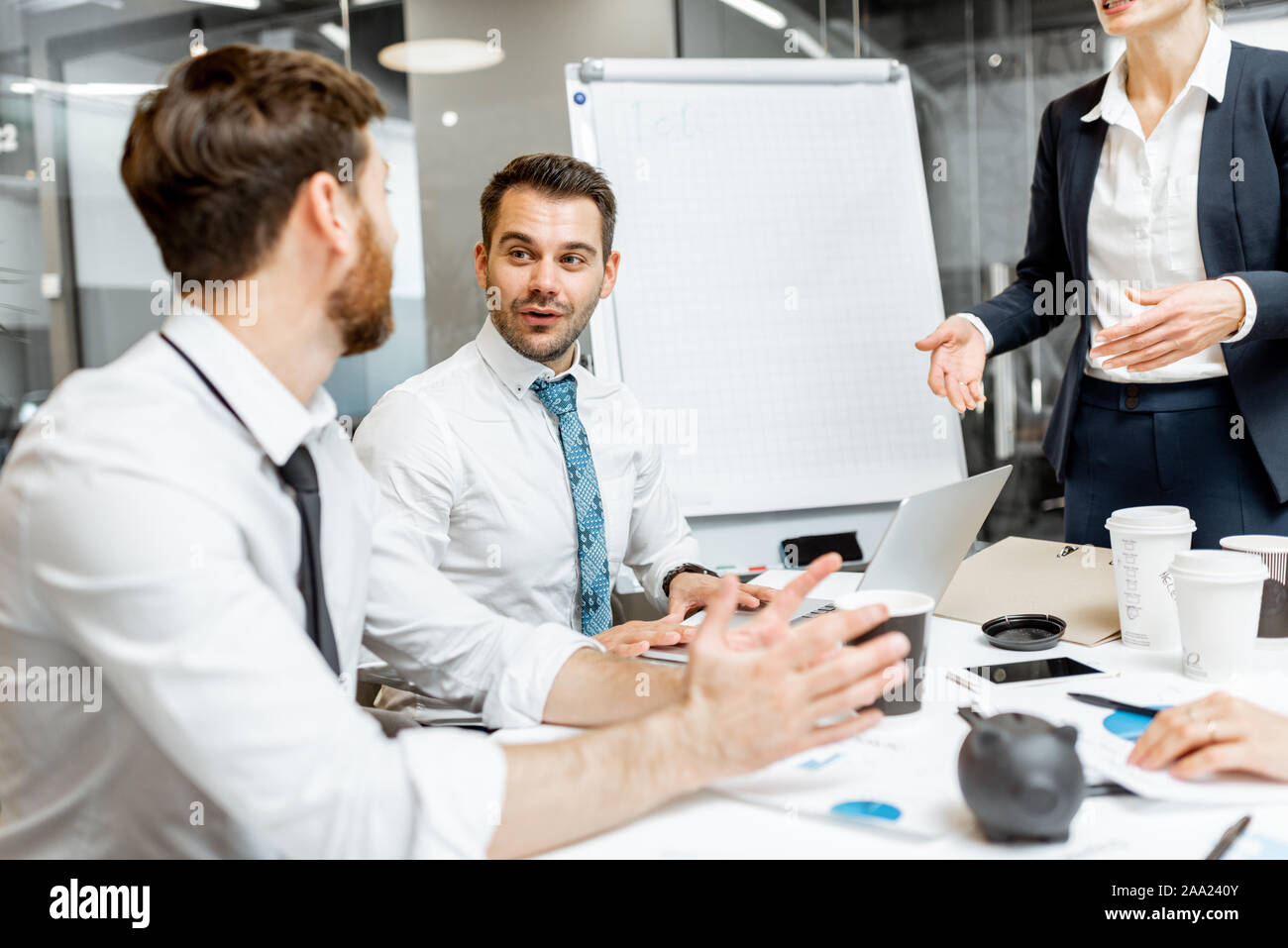 Two exhausted employees during a business conference with a team leader ...