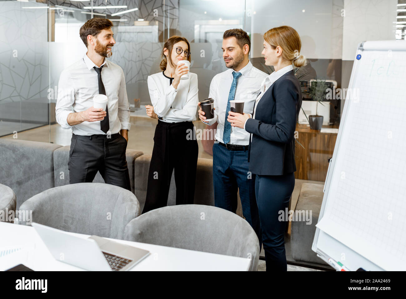 Business people having informal discussion during a coffee break after ...