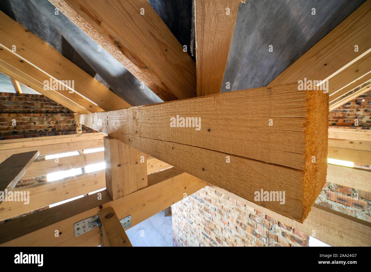 Attic of a building under construction with wooden beams of a roof ...