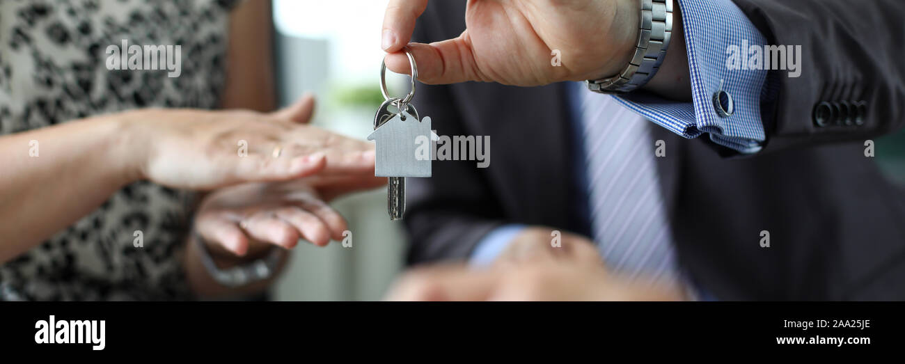Man giving keys to new house owner Stock Photo - Alamy
