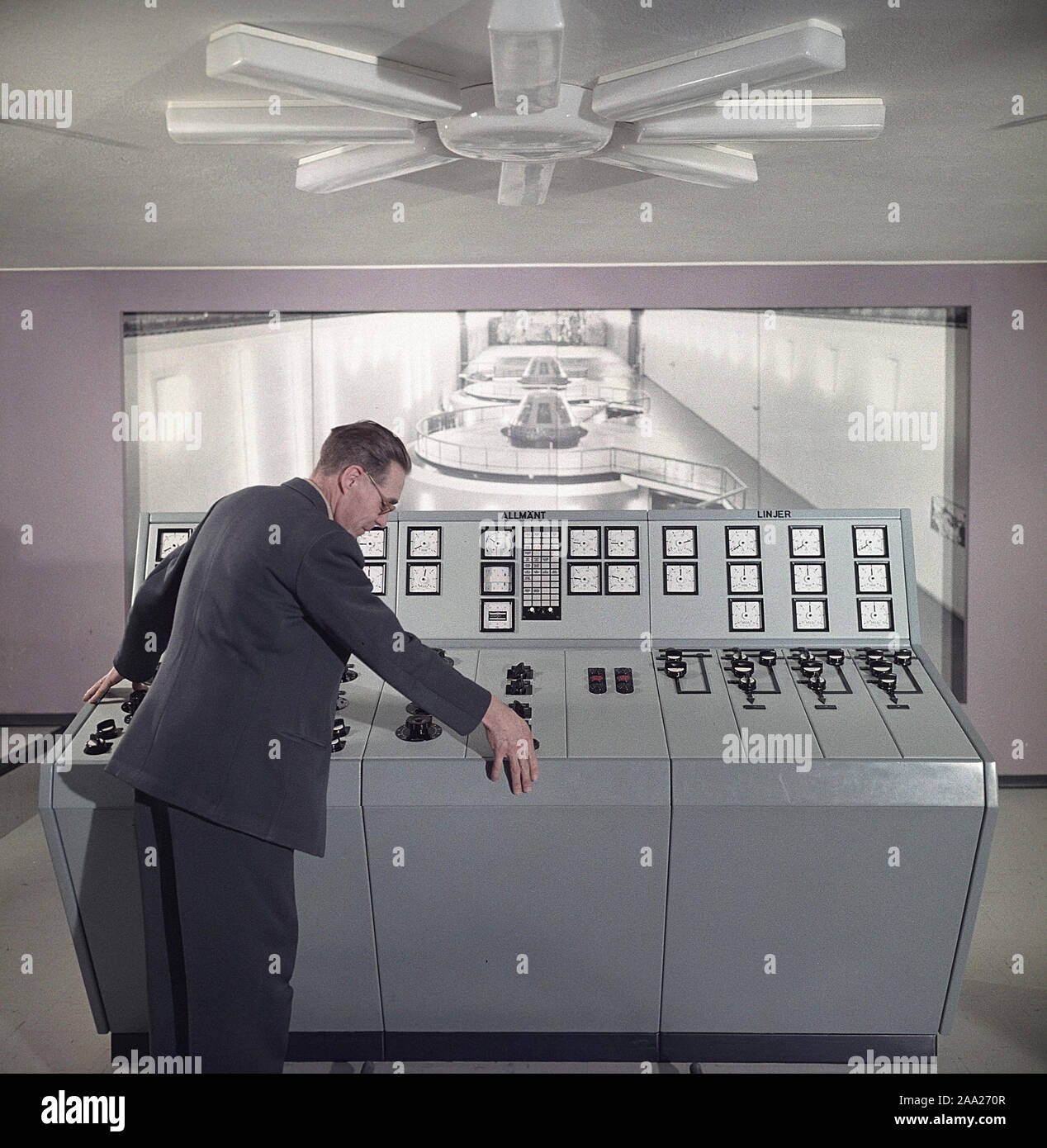 Technology of the 1960s. A man in front of a control panel at the ...