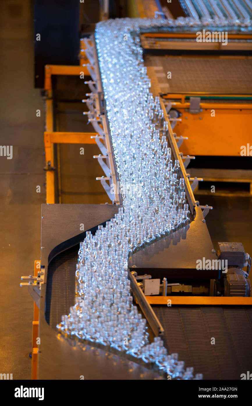 Glassworks. Glass industry. A lot of glass bottles on the conveyor ...
