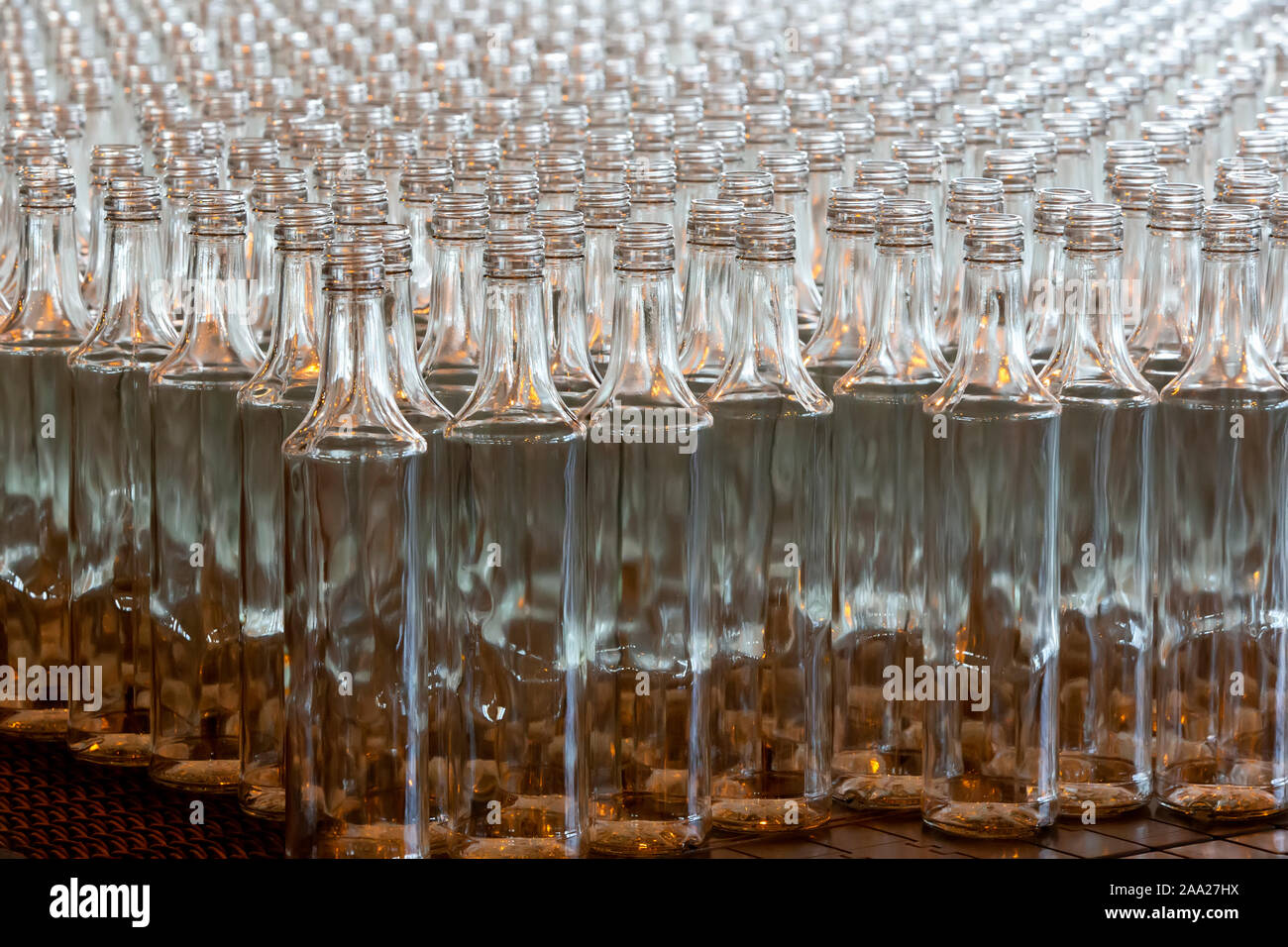 Glassworks. Glass industry. Many glass bottles on a factory conveyor ...