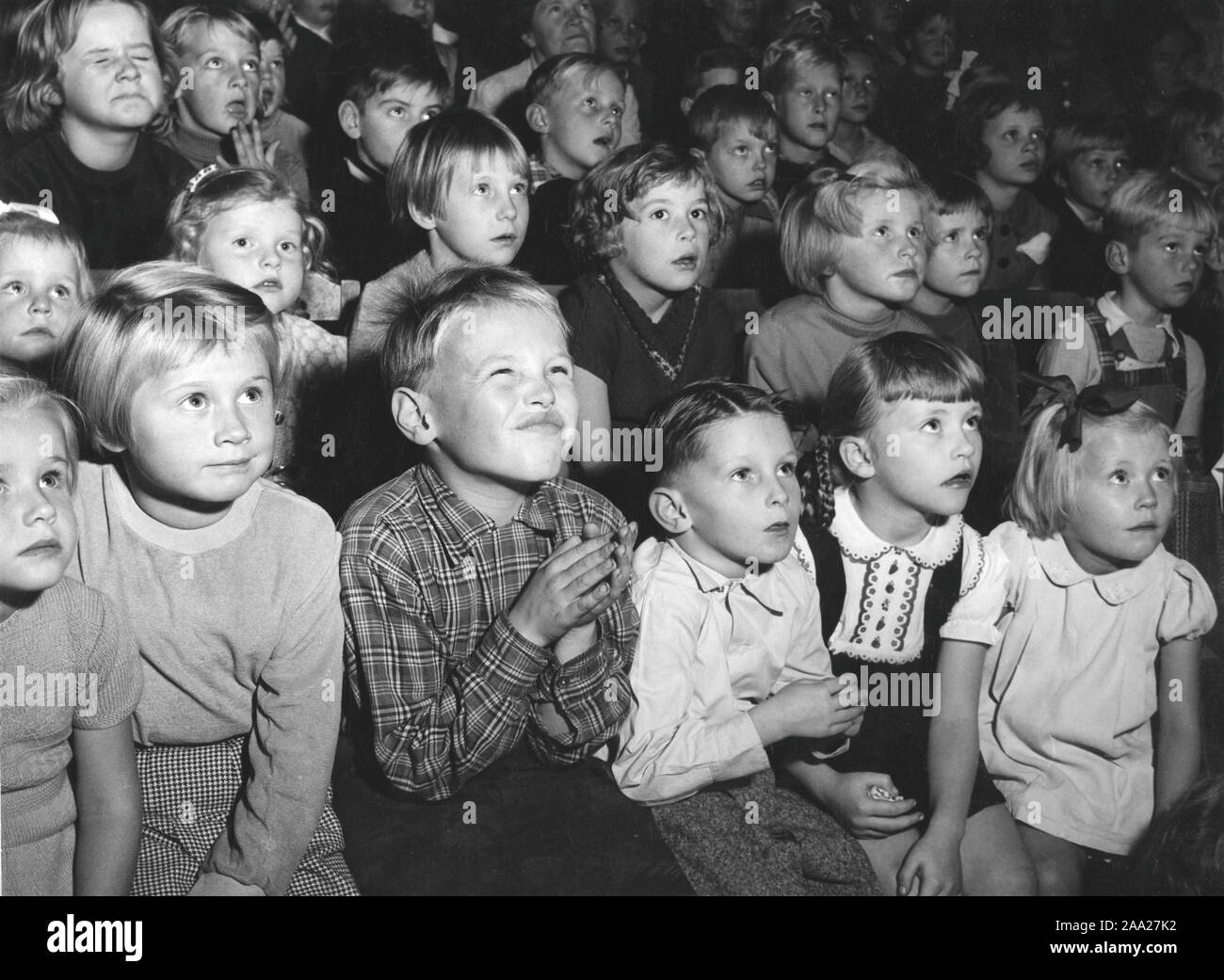 Children of the 1950s. An audience of children are sitting and pictured ...