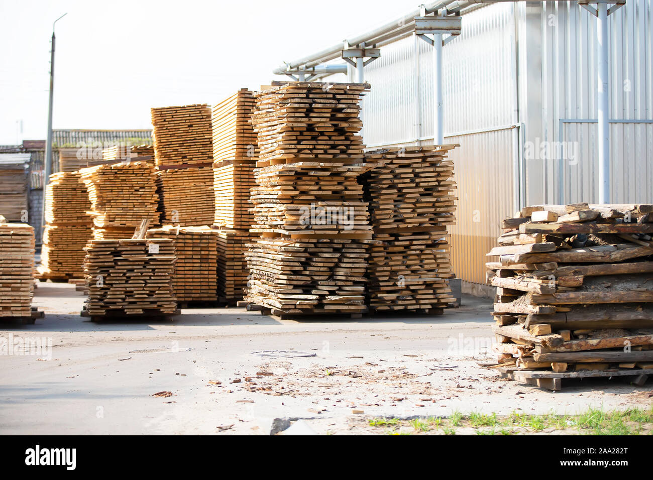 The territory of the wood processing plant.Folded wooden boards at a ...