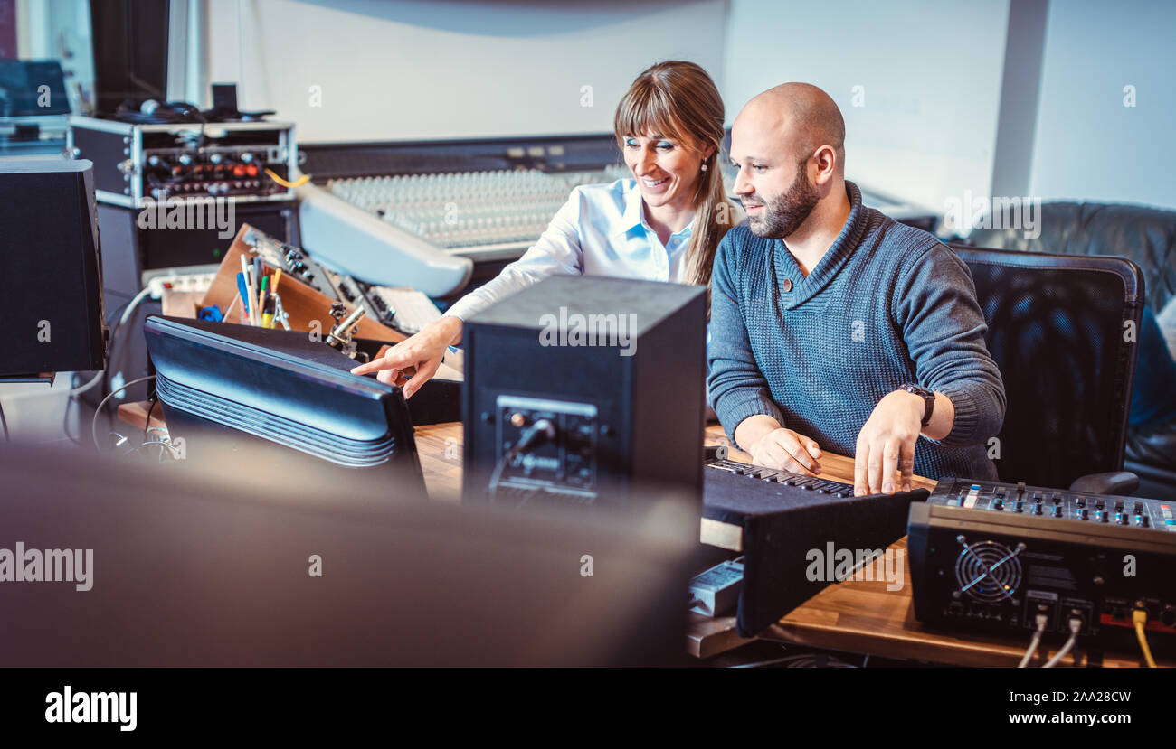 Singer or artist and sound engineer working in the studio Stock Photo ...