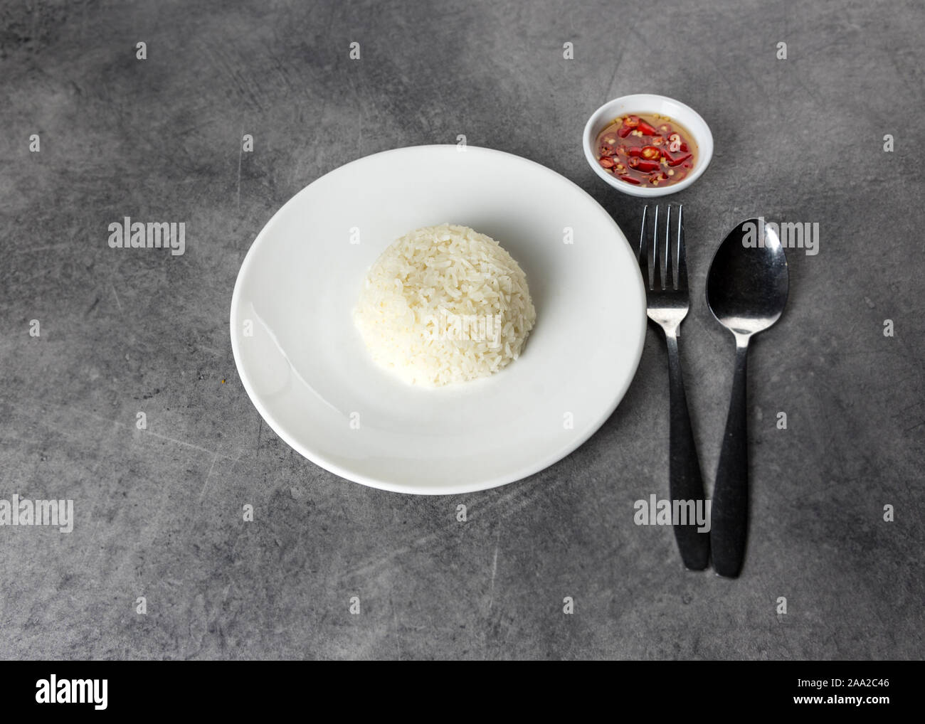 Jasmine rice serve on a plate with spoon and fork in restaurant, plate ...