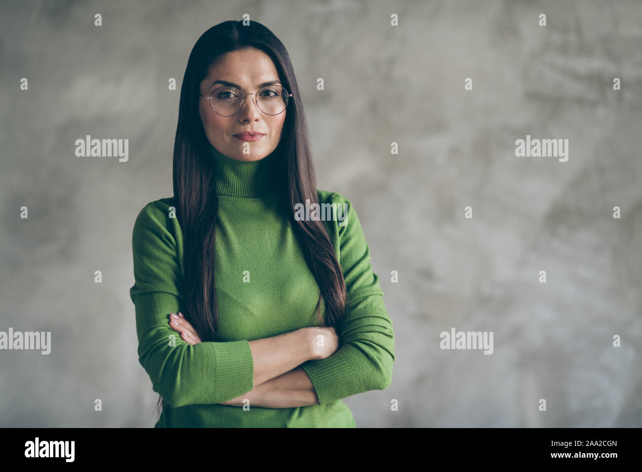 Photo of serious confident woman with hands folded looking at you ...