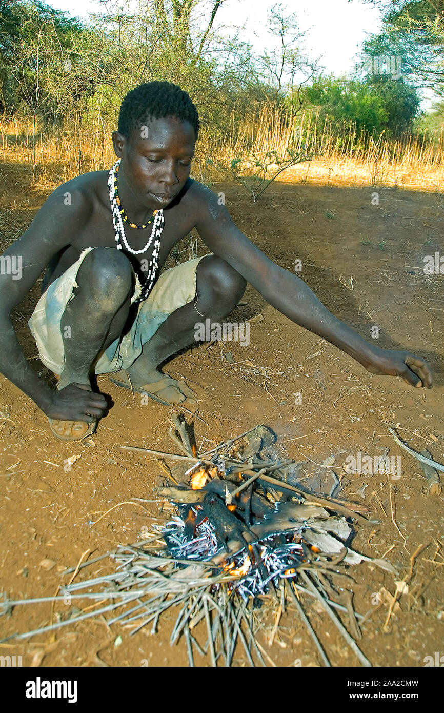 Hadzabe bushman making up a fire. Lake Eyasi, northern Tanzania Stock ...