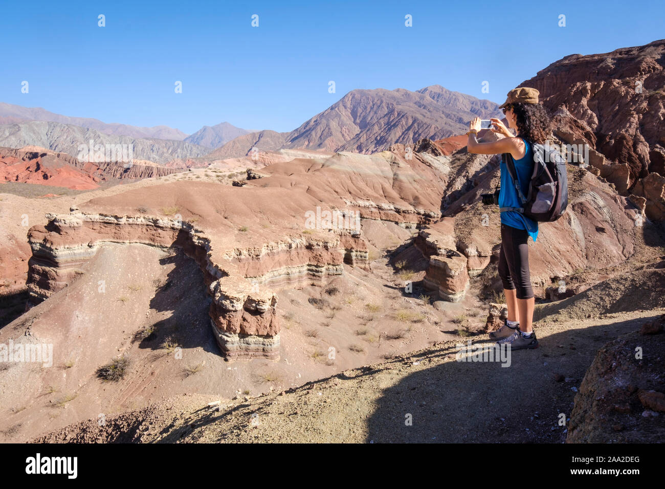 Female tourist photographing a panoramic view of the colorful ...