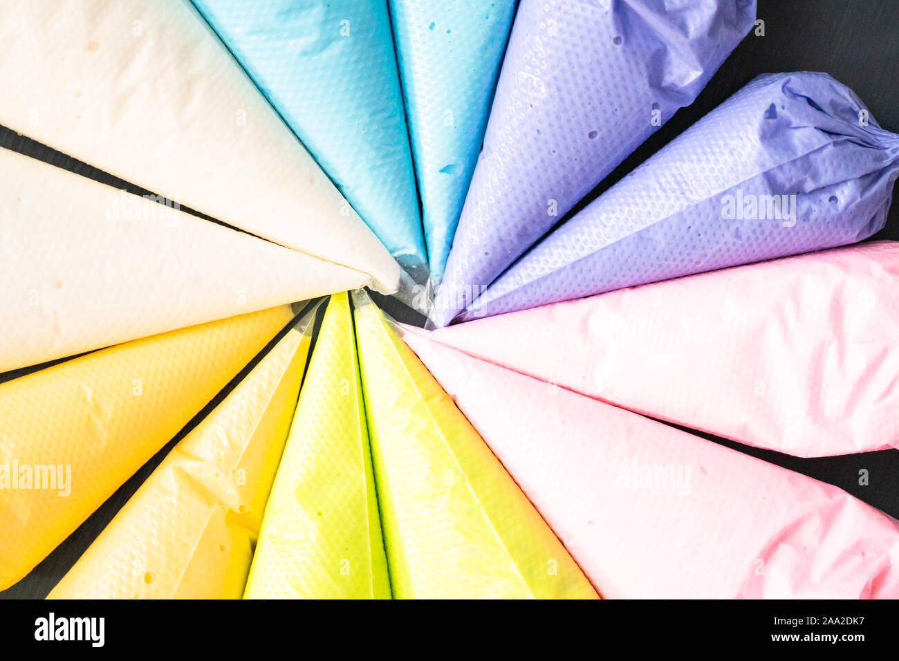 Variety of colors of royal icing in plastic piping bags Stock Photo - Alamy