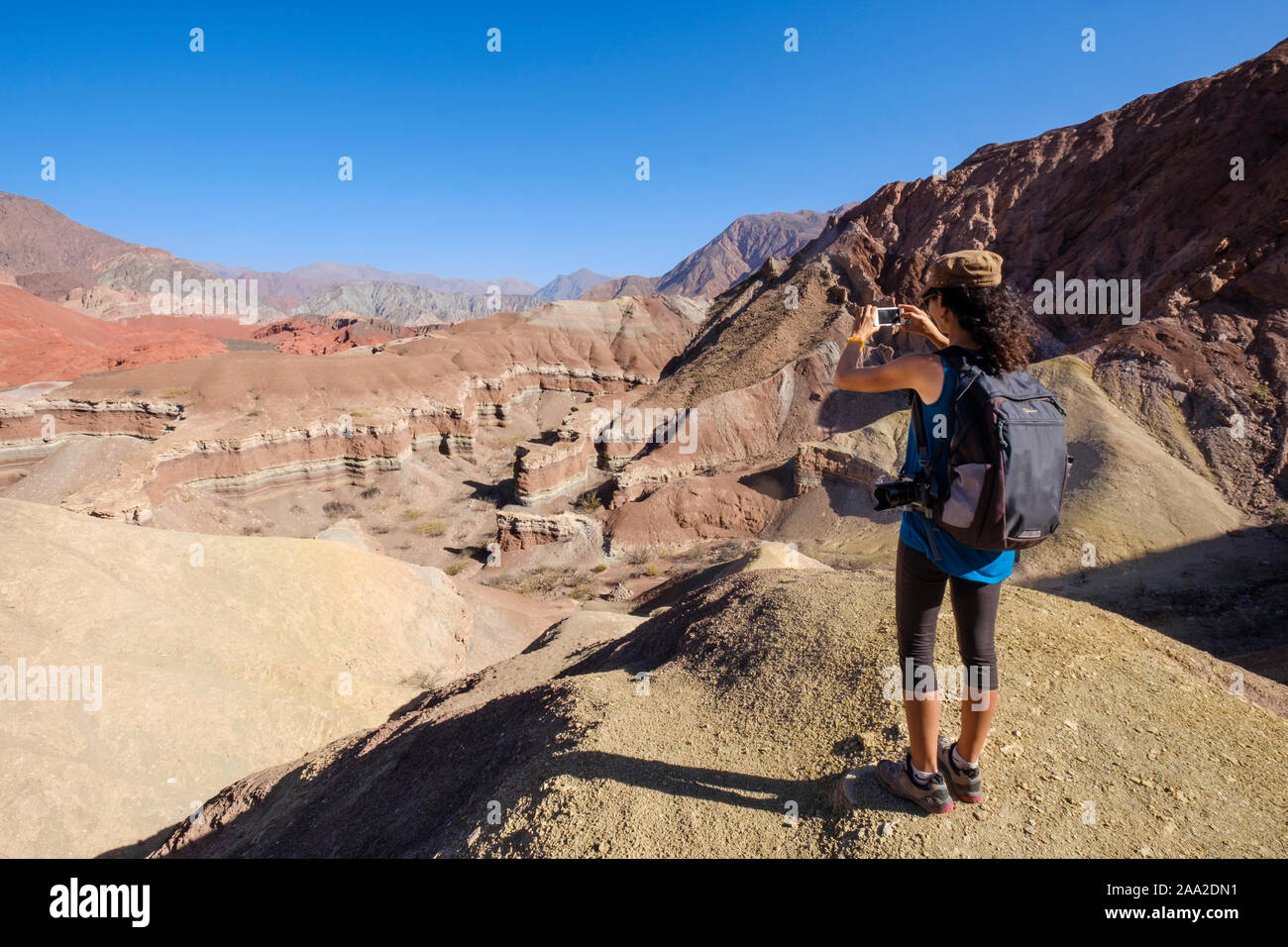 Female tourist photographing a panoramic view of the colorful ...