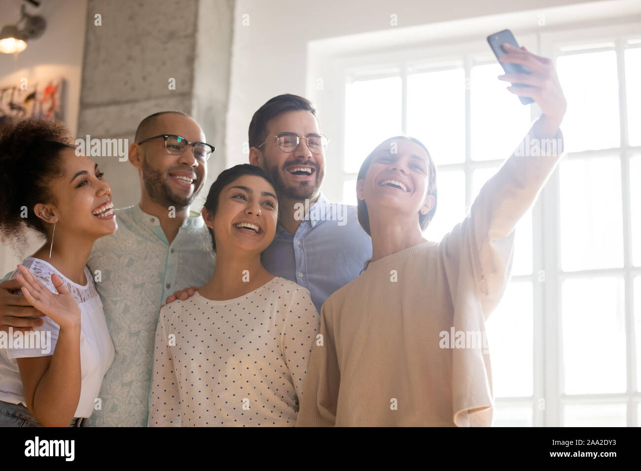 Group of laughing students having fun together, recording funny video ...
