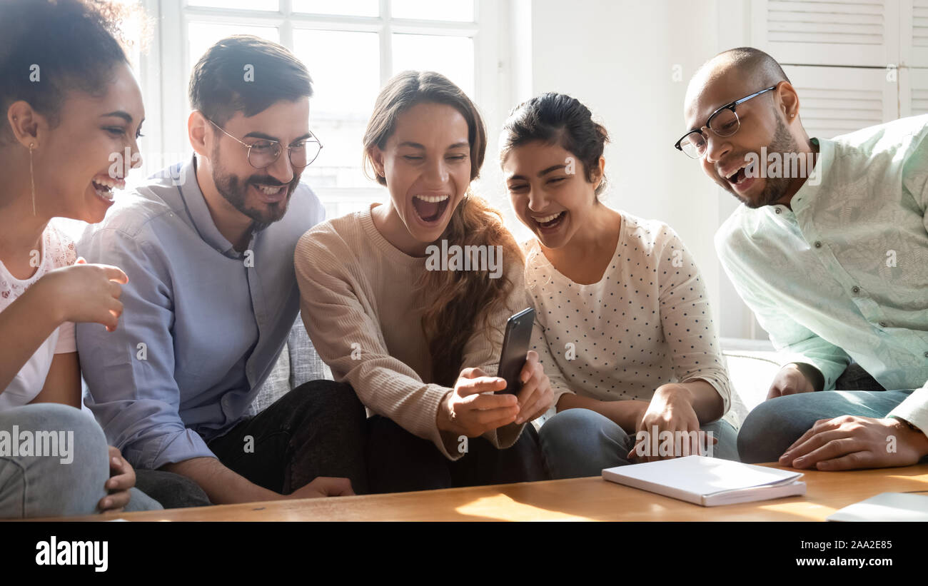 Crazy millennial diverse classmates enjoying spending time together ...