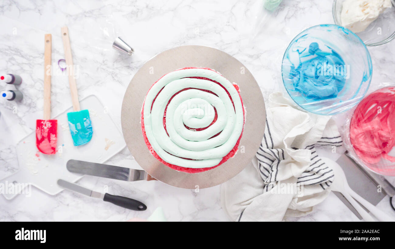 Frosting round three-layer vanilla cake with buttercream frosting Stock ...