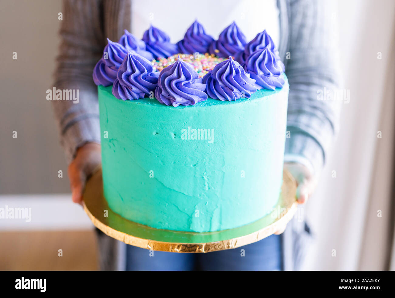 Birthday cake with turquoise buttercream and purple rosettes and ...