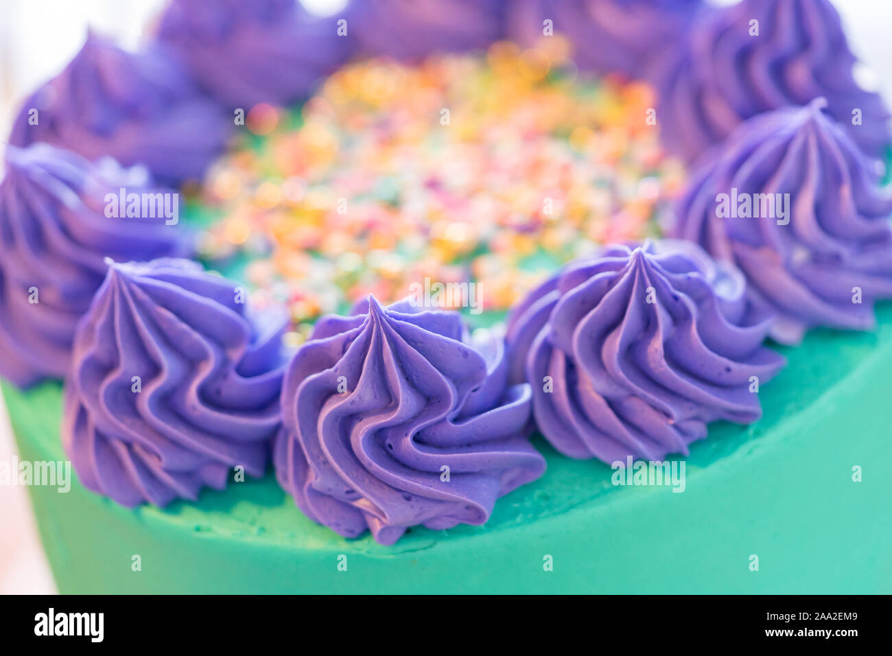 Birthday cake with turquoise buttercream and purple rosettes and ...